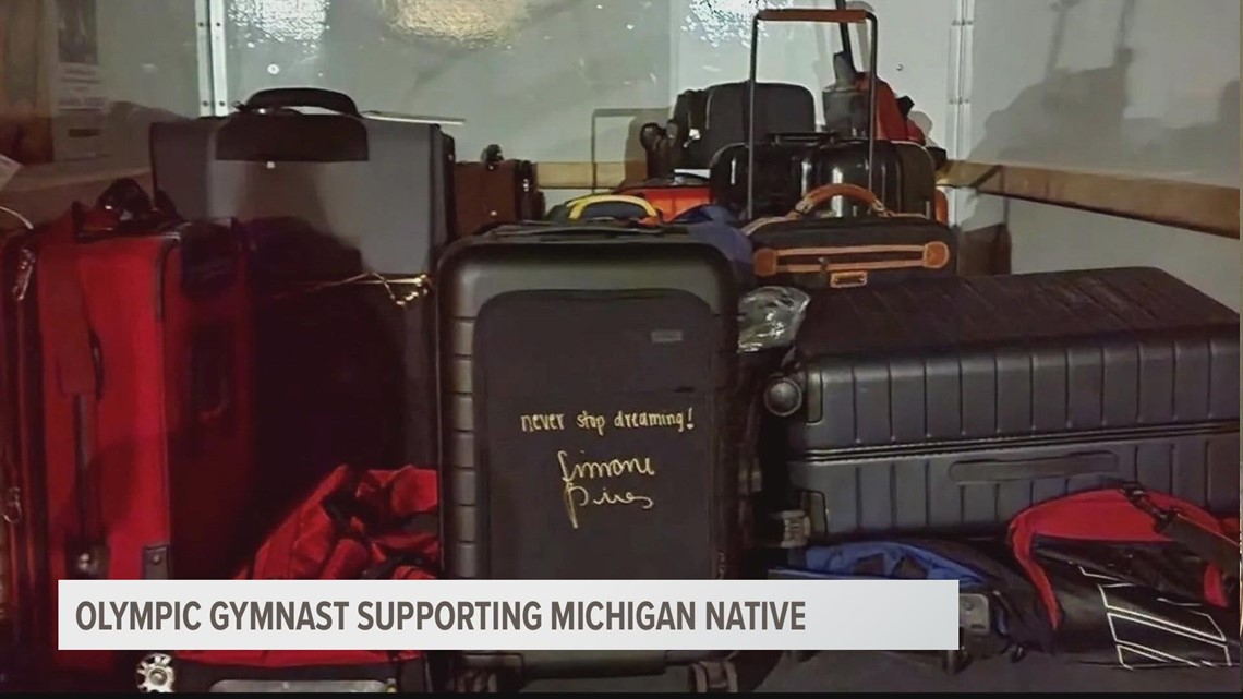 Simone Biles signs suitcases for Michigan foster children | wzzm13.com
