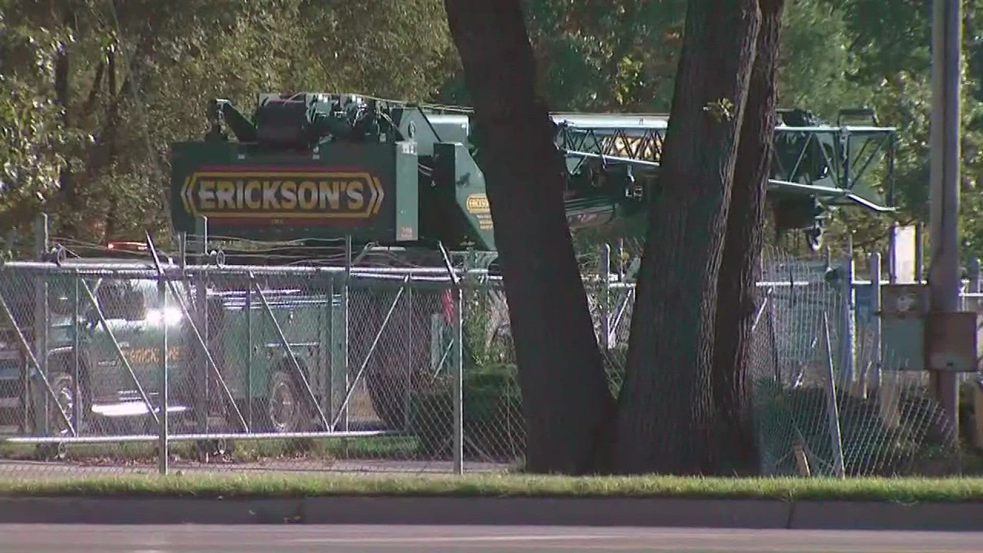 Shirtless father leaves baby, steals crane to drive through fences and ...
