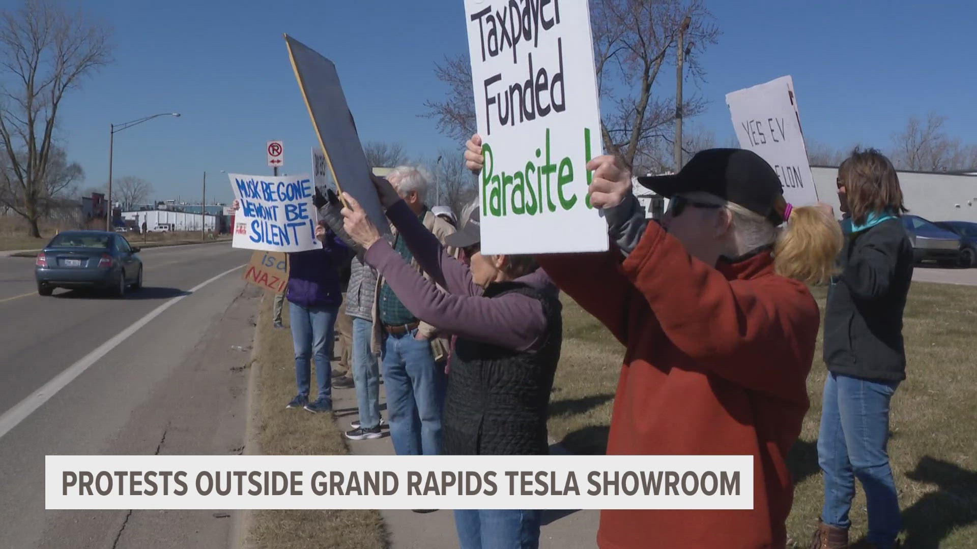 Anti-DOGE, Musk protest at Tesla showroom in Grand Rapids | wzzm13.com