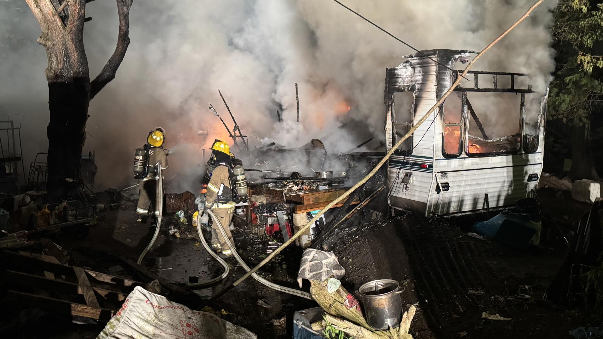 2 people escape burning travel trailer in Casco Township | wzzm13.com