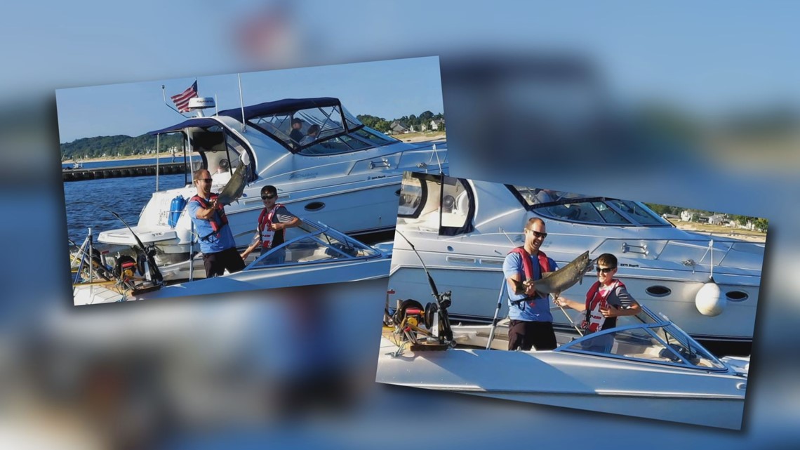 'TOUCHED' | Passing boater captures sweet father-son moment in Grand Haven | wzzm13.com