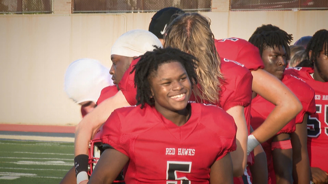 West Side neighbors stand with Grand Rapids Union football team during ...