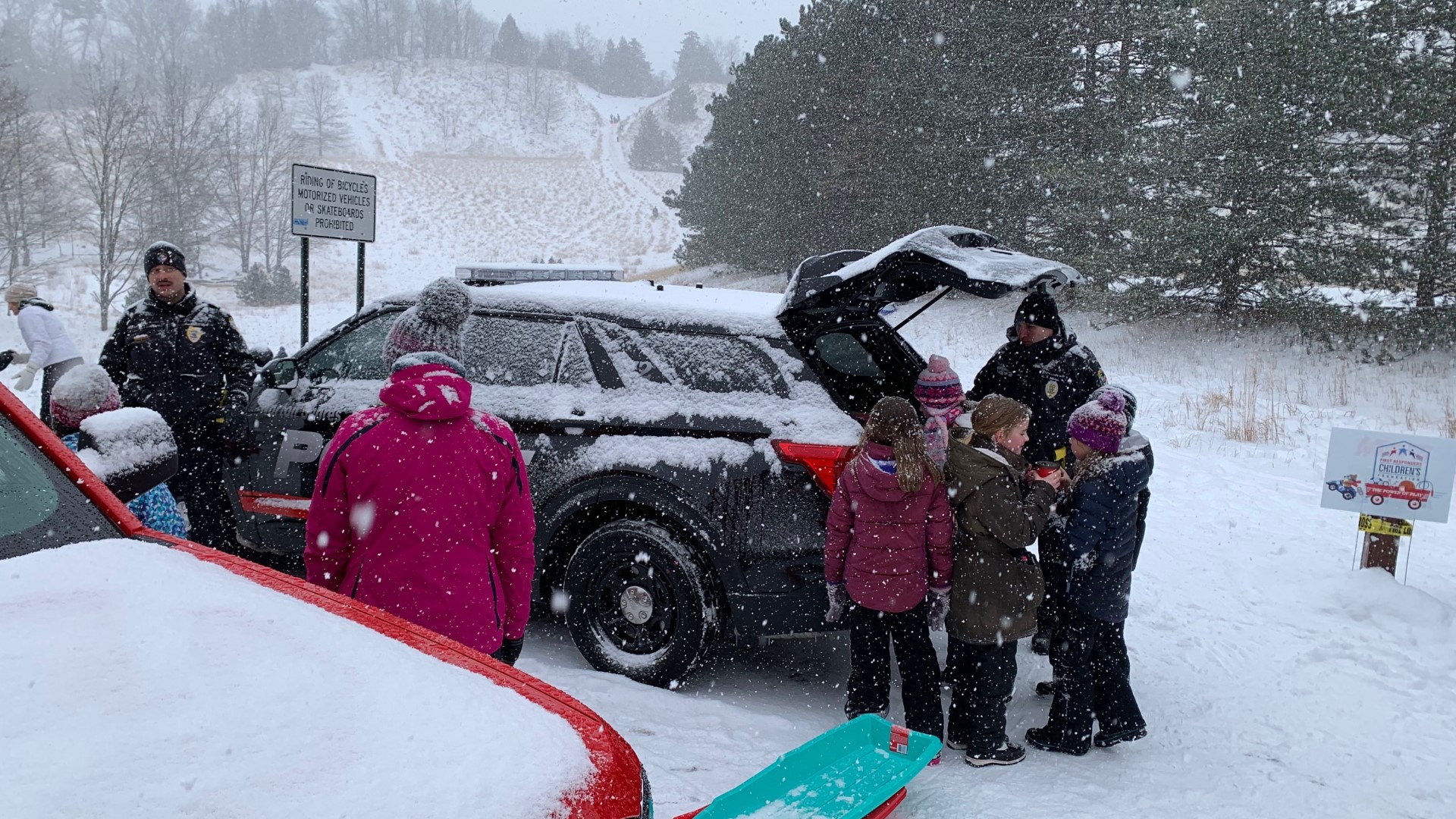 Norton Shores law enforcement surprises sledding families | wzzm13.com