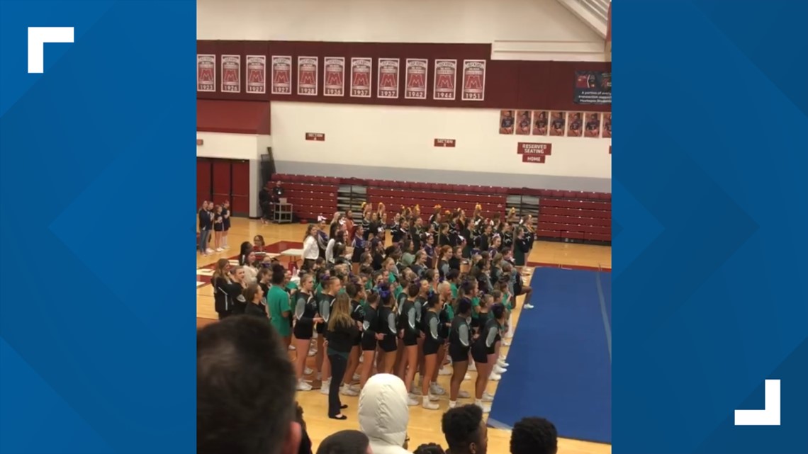 Cheerleaders sing national anthem at cheer competition | wzzm13.com